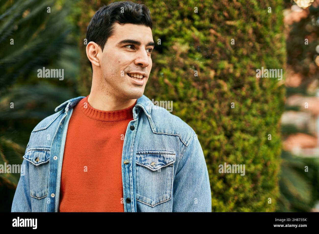 Young hispanic man smiling happy standing at the city Stock Photo - Alamy