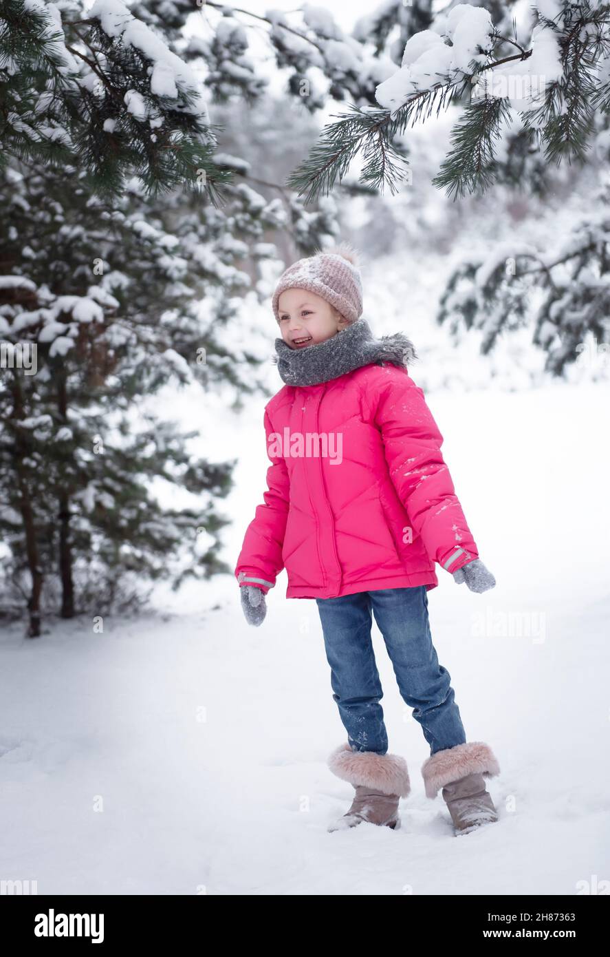Child in winter. A little girl, playing in the winter outside. A ...