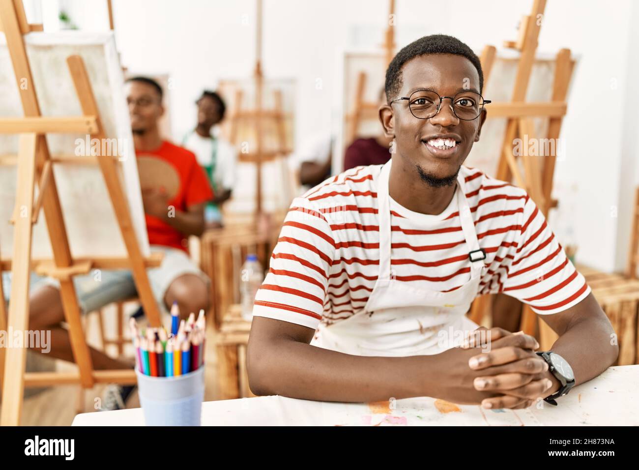 Group of young african american artist students drawing at art studio ...