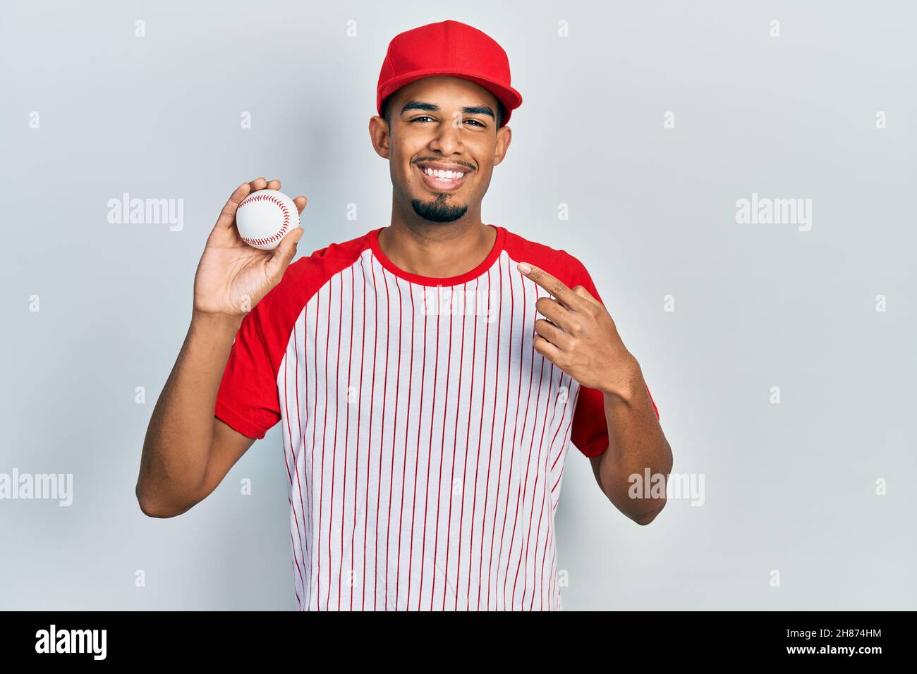 Young african american man wearing baseball uniform suffering from ...