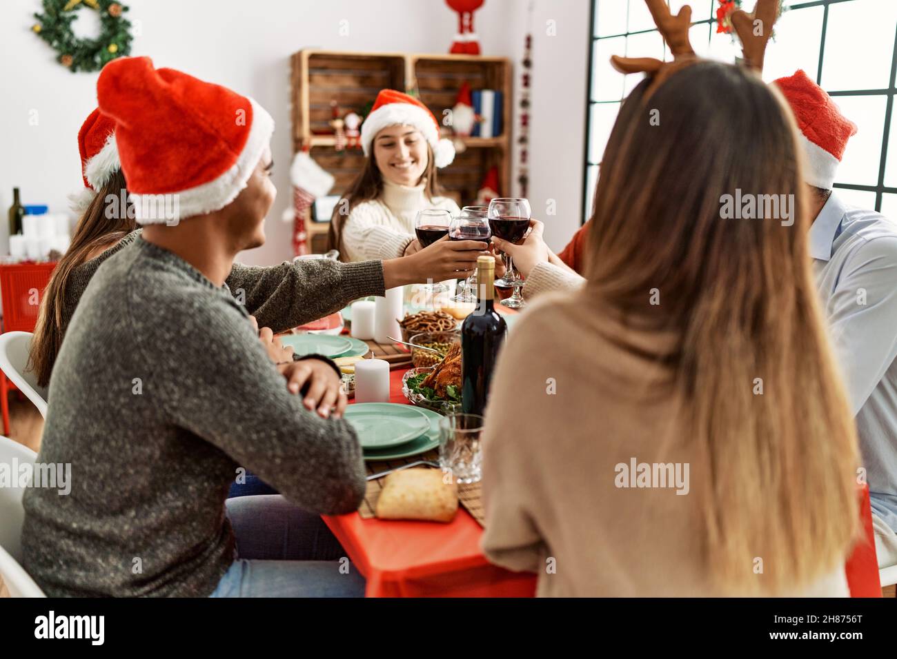 Group of young people smiling happy celebrating christmas toasting with ...