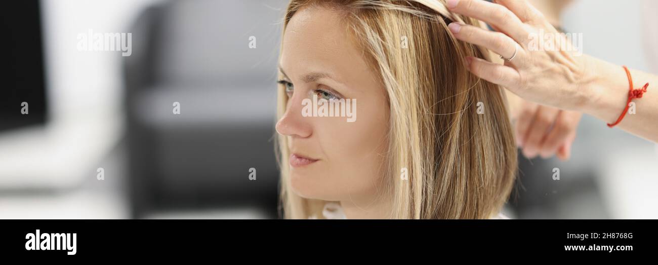 Hairdresser making hair styling to woman client in beauty salon Stock ...