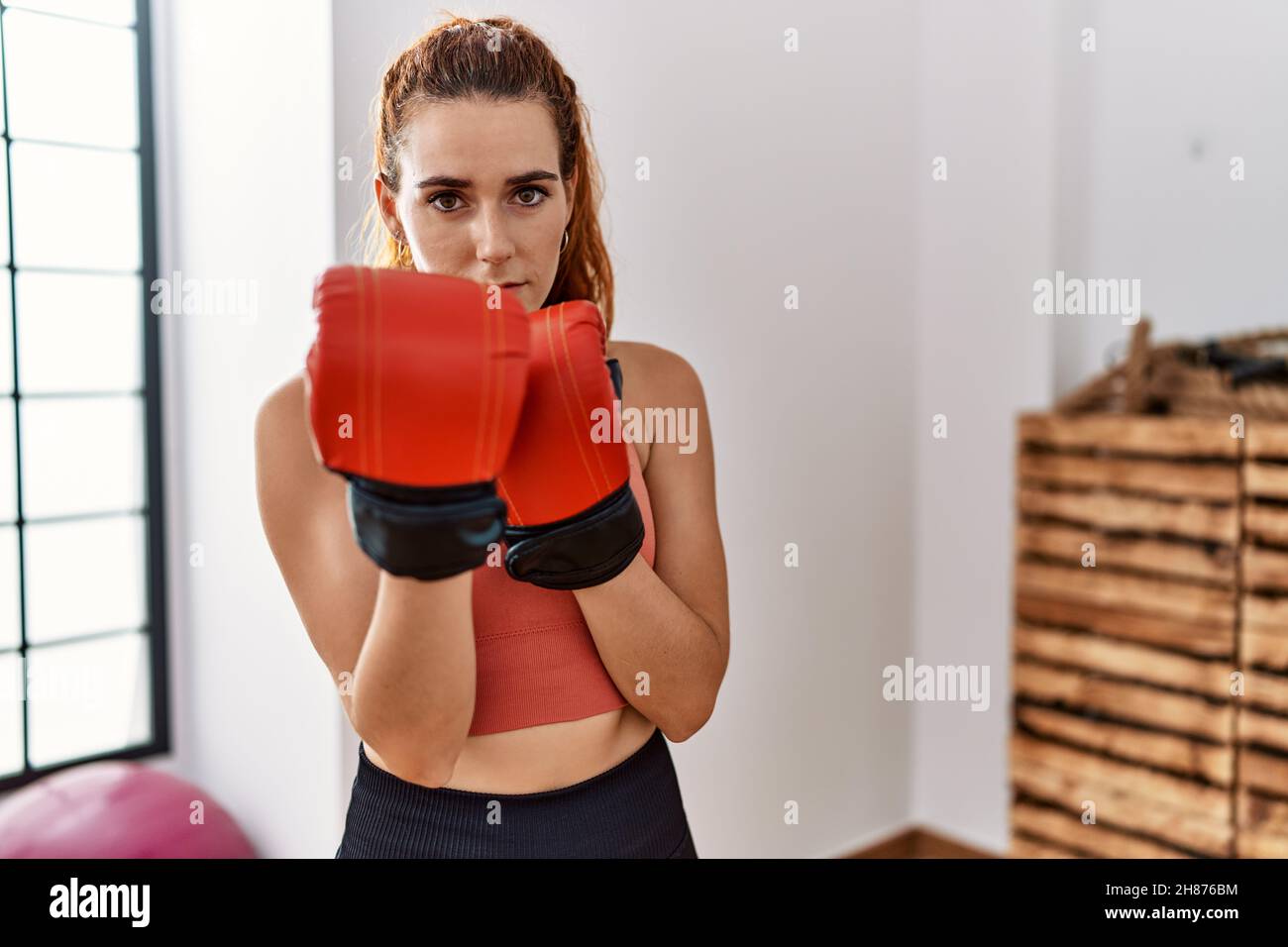 Young redhead woman boxing at sport center Stock Photo - Alamy