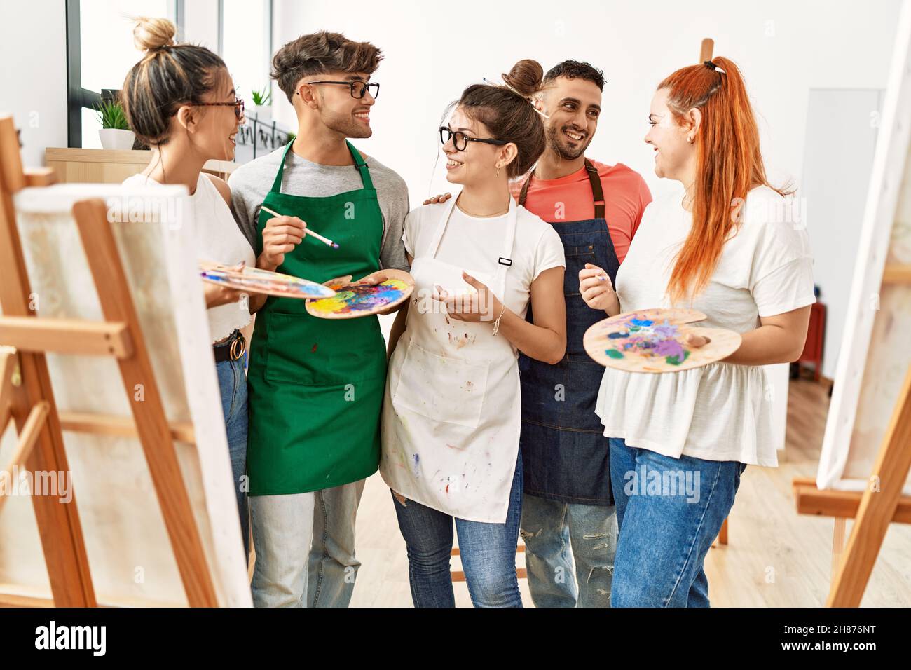 Group of young paint students smiling happy standing at art studio ...