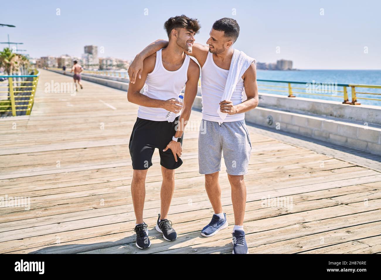 Two hispanic men sporty couple smiling confident and hugging each other ...