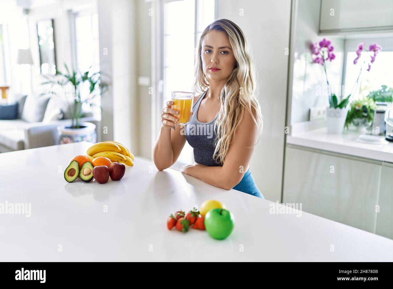 Young caucasian fitness woman wearing sportswear drinking healthy ...
