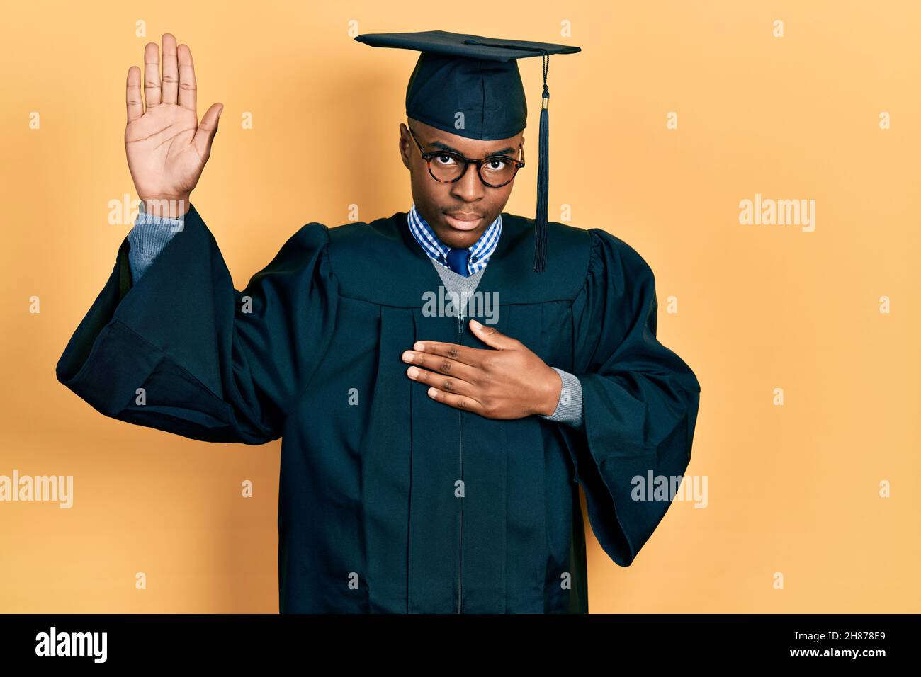 Young african american man wearing graduation cap and ceremony robe ...
