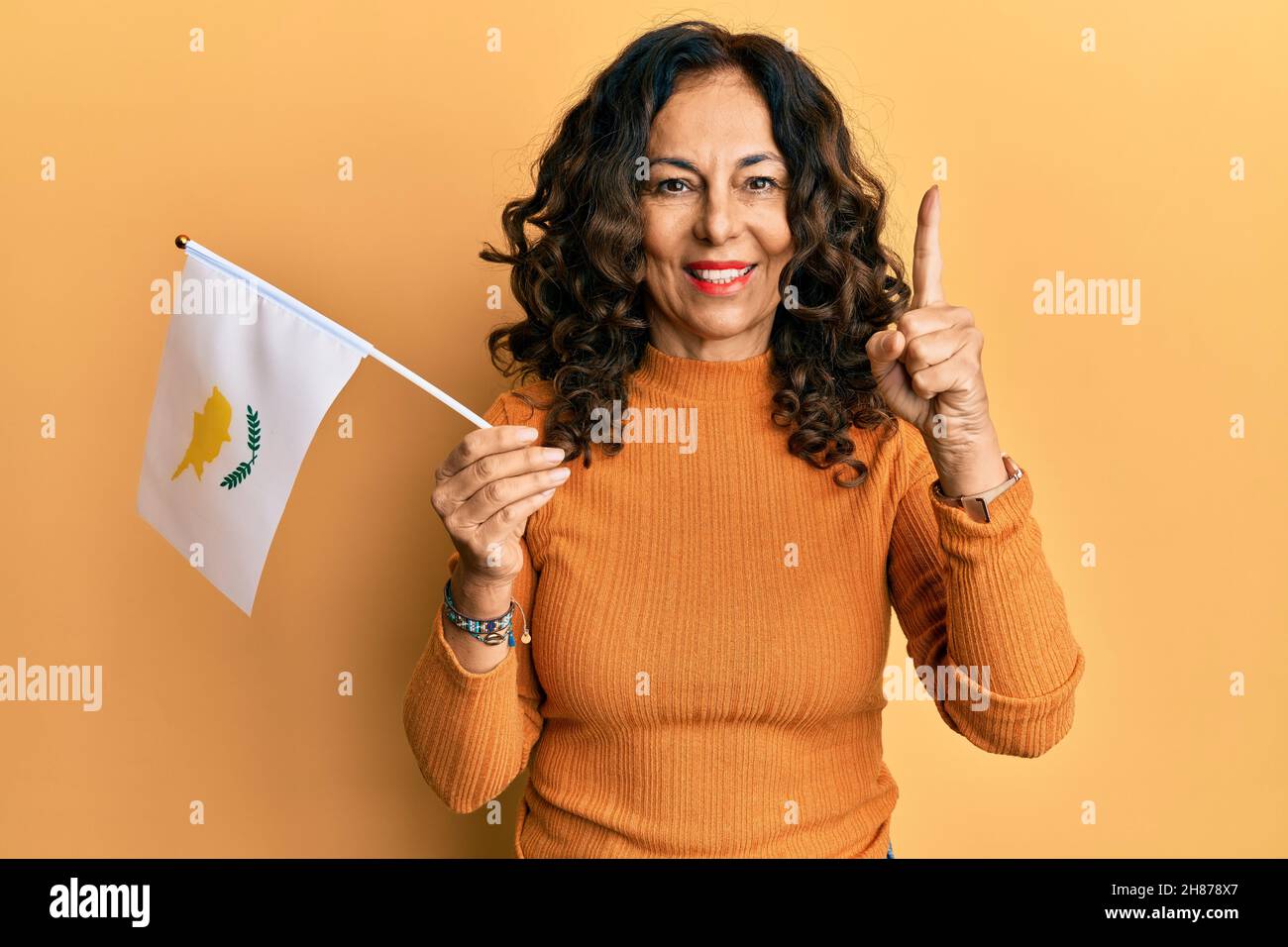 Middle age hispanic woman holding cyprus flag smiling with an idea or ...