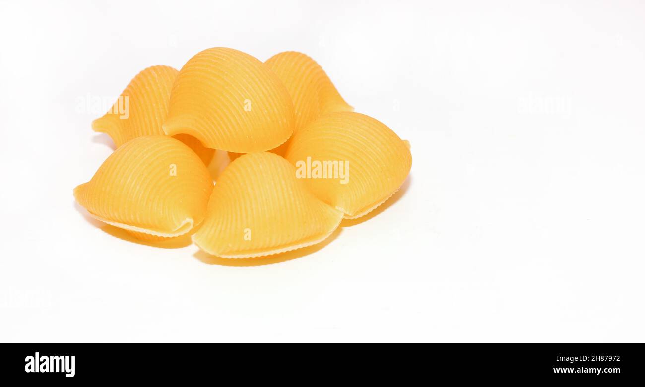 shell shaped pasta on a white background. A modern set for healthy ...
