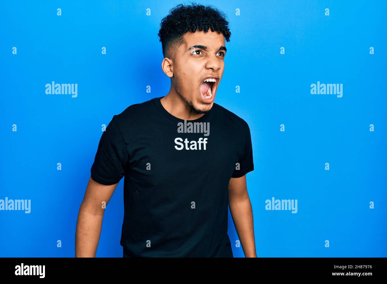 Young african american man wearing staff t shirt angry and mad ...