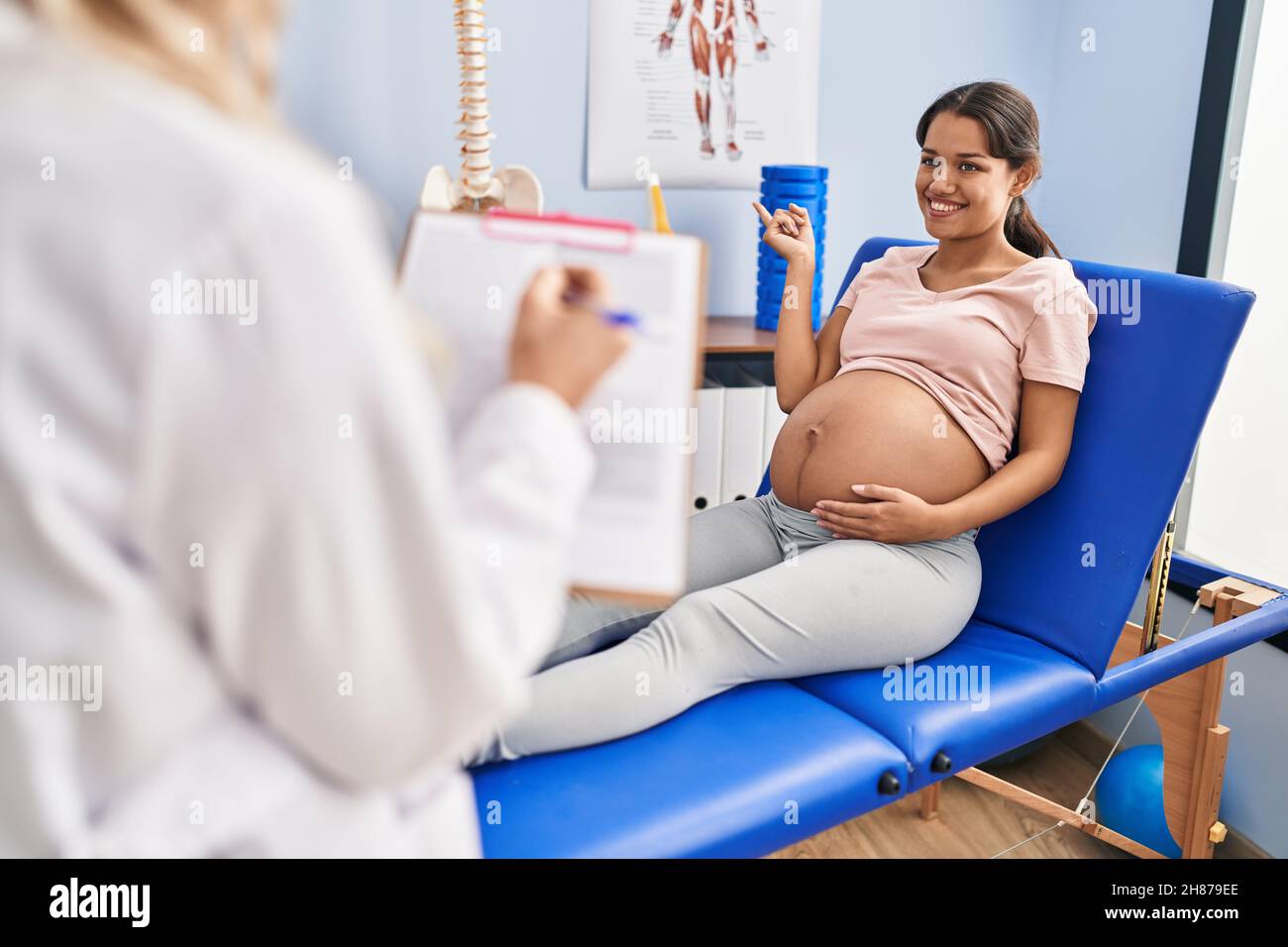 Young pregnant woman at physiotherapist clinic angry and mad screaming ...