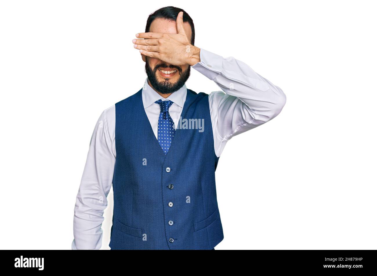Young man with beard wearing business vest smiling and laughing with ...