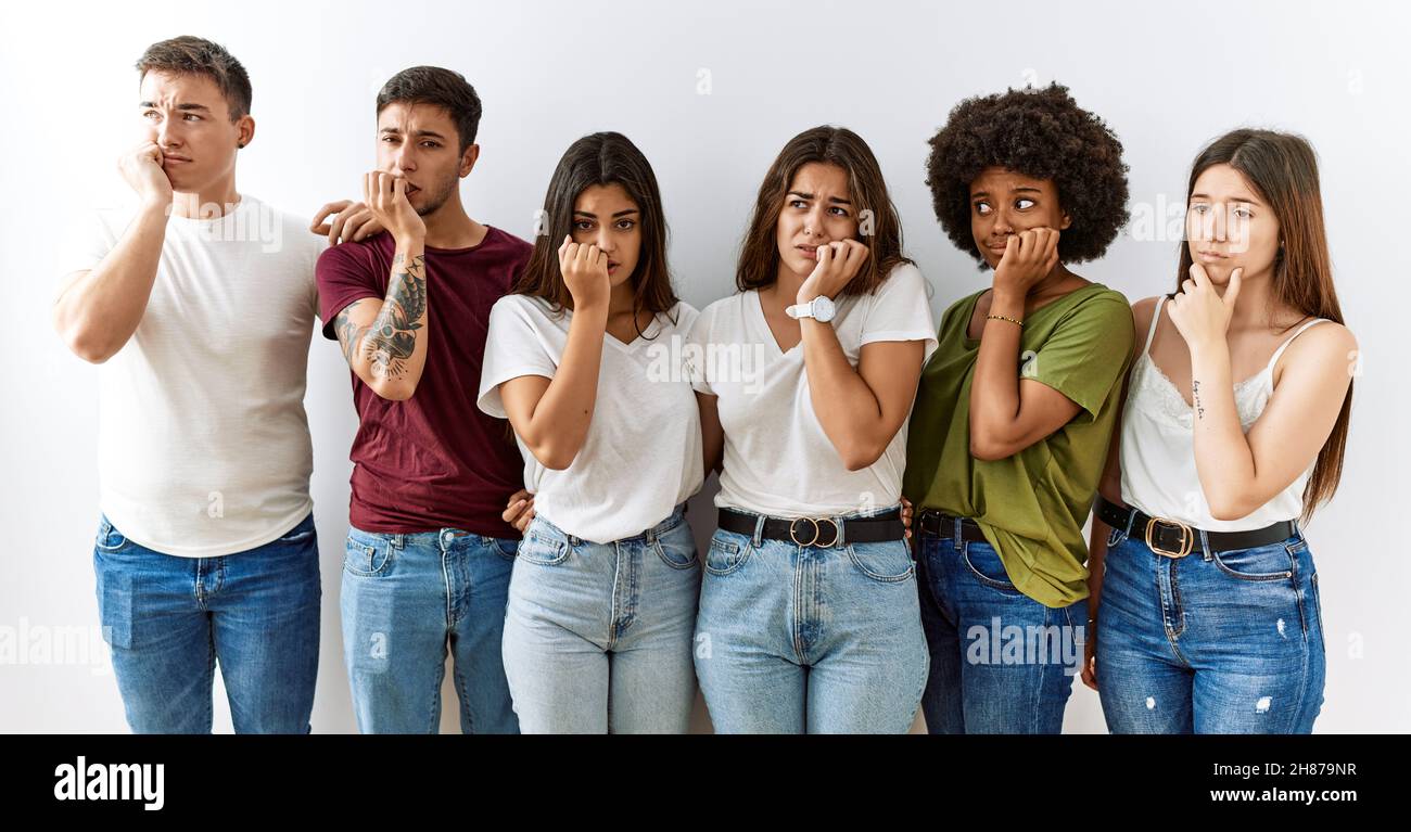 Group of young friends standing together over isolated background ...