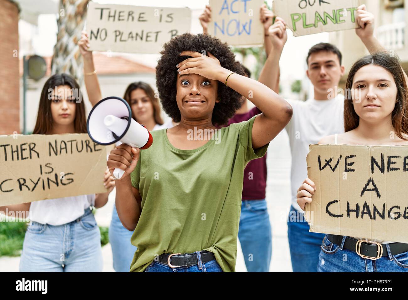 Group of young friends protesting and giving slogans at the street ...