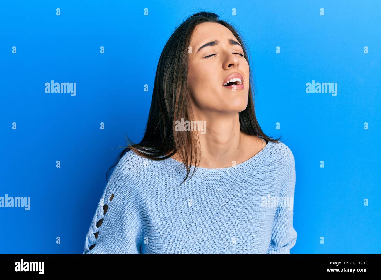 Young hispanic girl wearing casual clothes with hand on stomach because ...