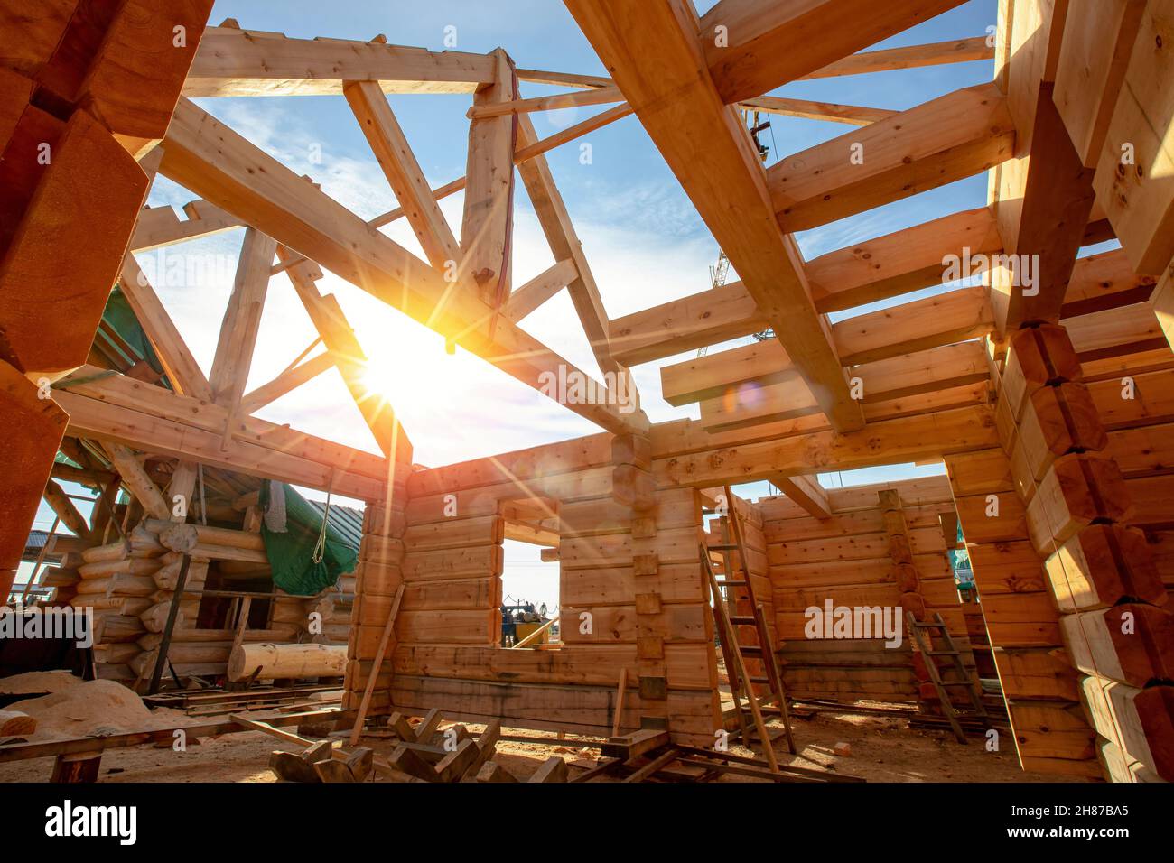 New house wooden log construction interior with exposed framing roof ...