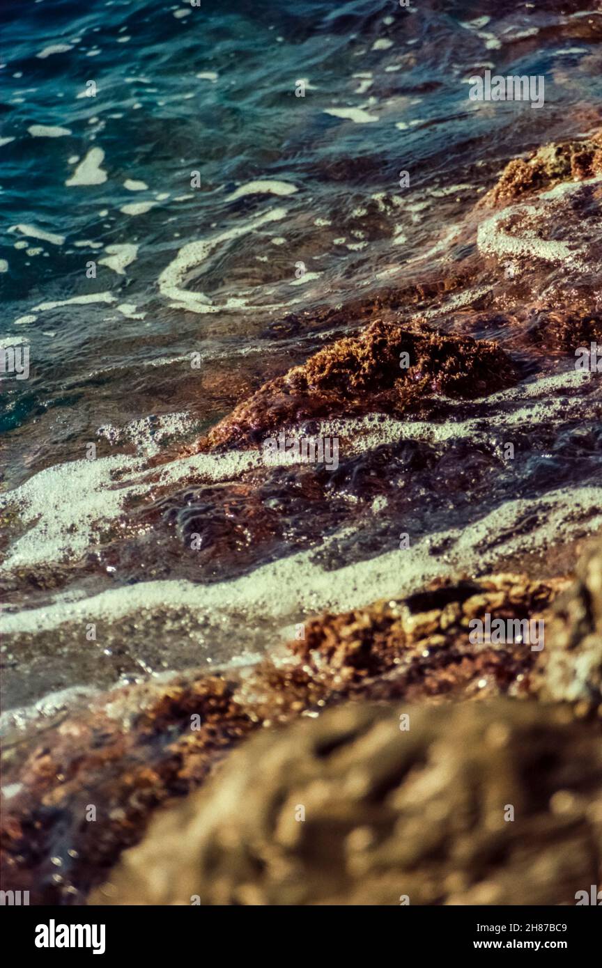 Patterns and foam of waves in the ocean, shot with analogue color film ...