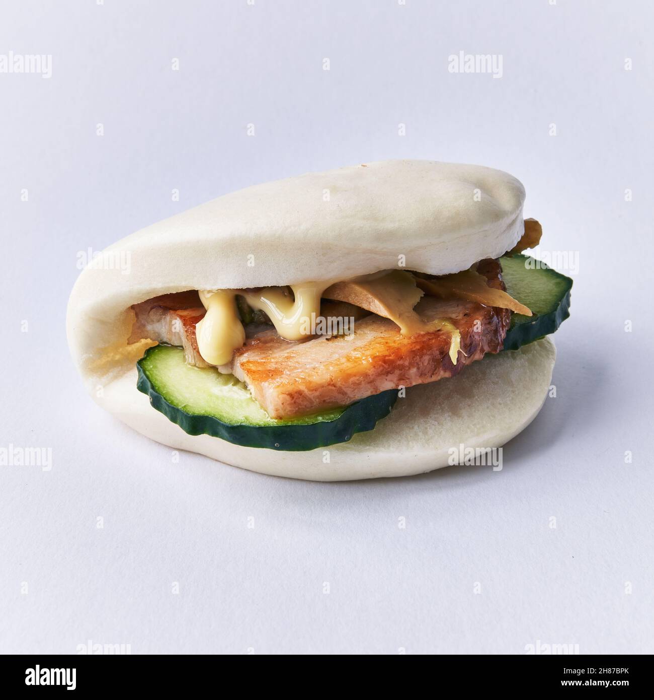 Single bao bun isolated on a white background Stock Photo - Alamy