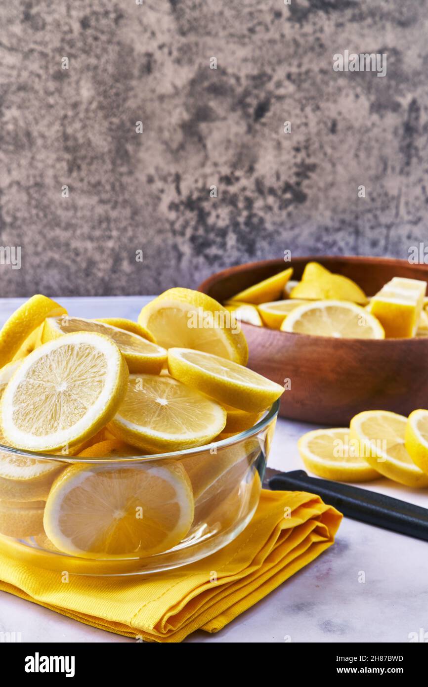 Bowls of slices of lemon on a marble surface Stock Photo - Alamy