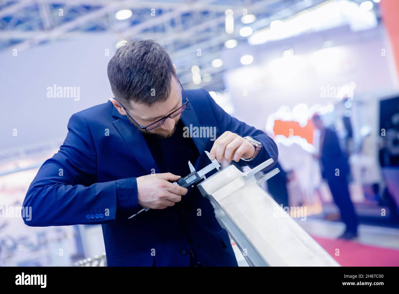 Engineer checks dimensions with vernier caliper control quality of ...