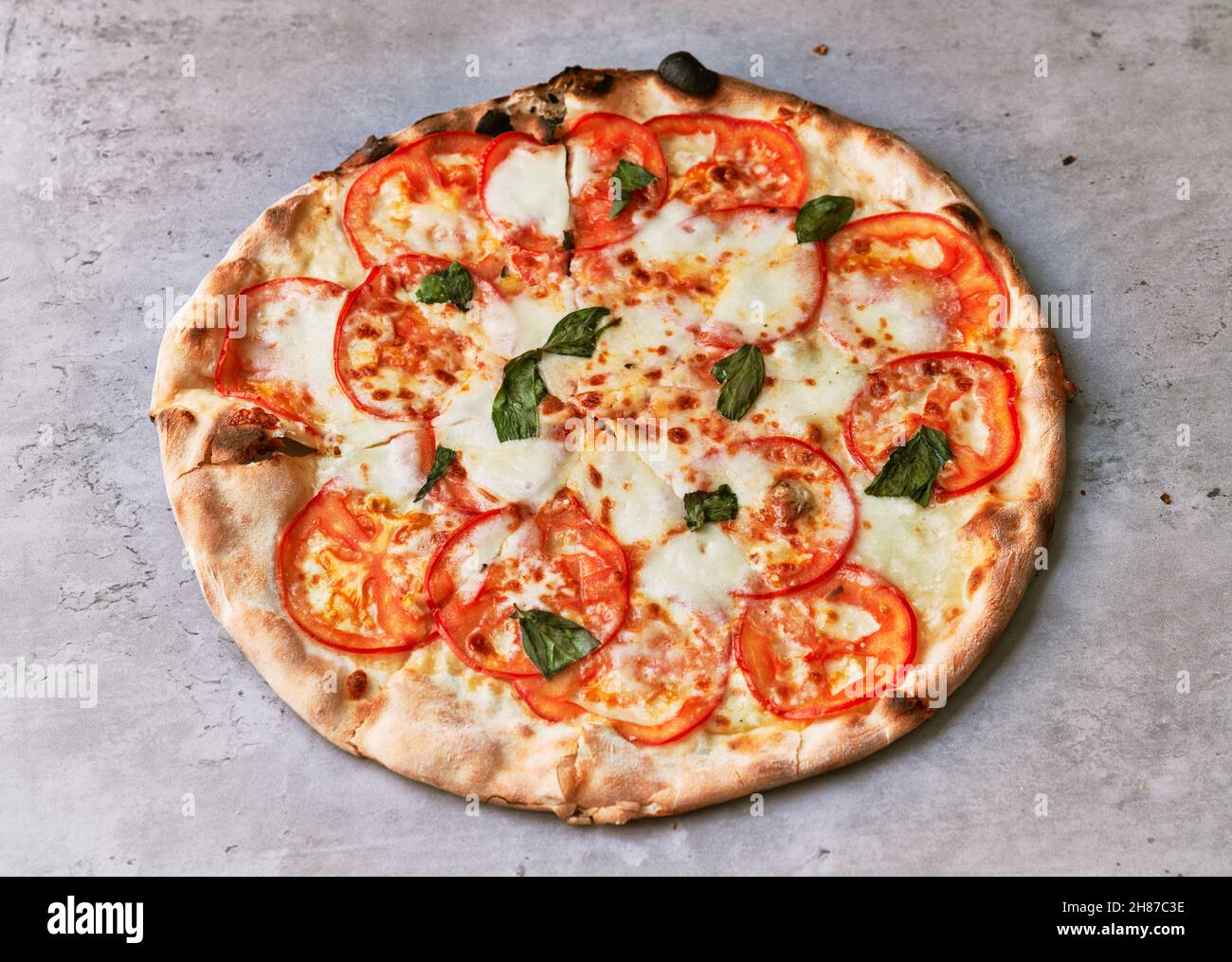 Delicious italian pizza on a concrete surface Stock Photo - Alamy