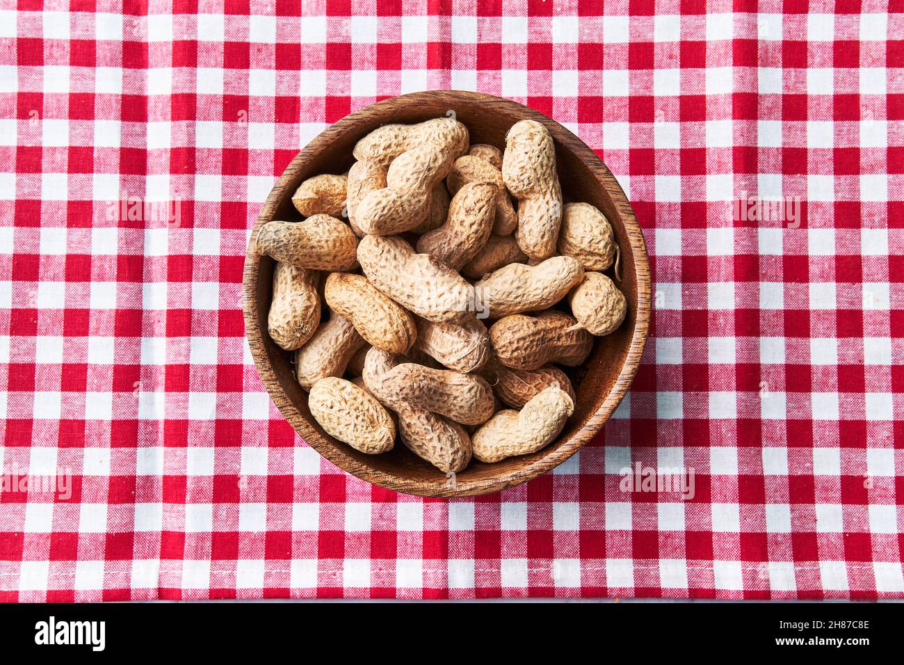 Bowl of peanuts with shell on a textile surface Stock Photo - Alamy