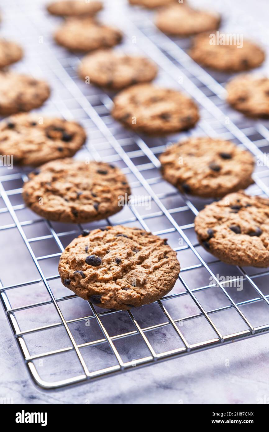 Chocolate cookies served on a grid rack on a marble table Stock Photo ...