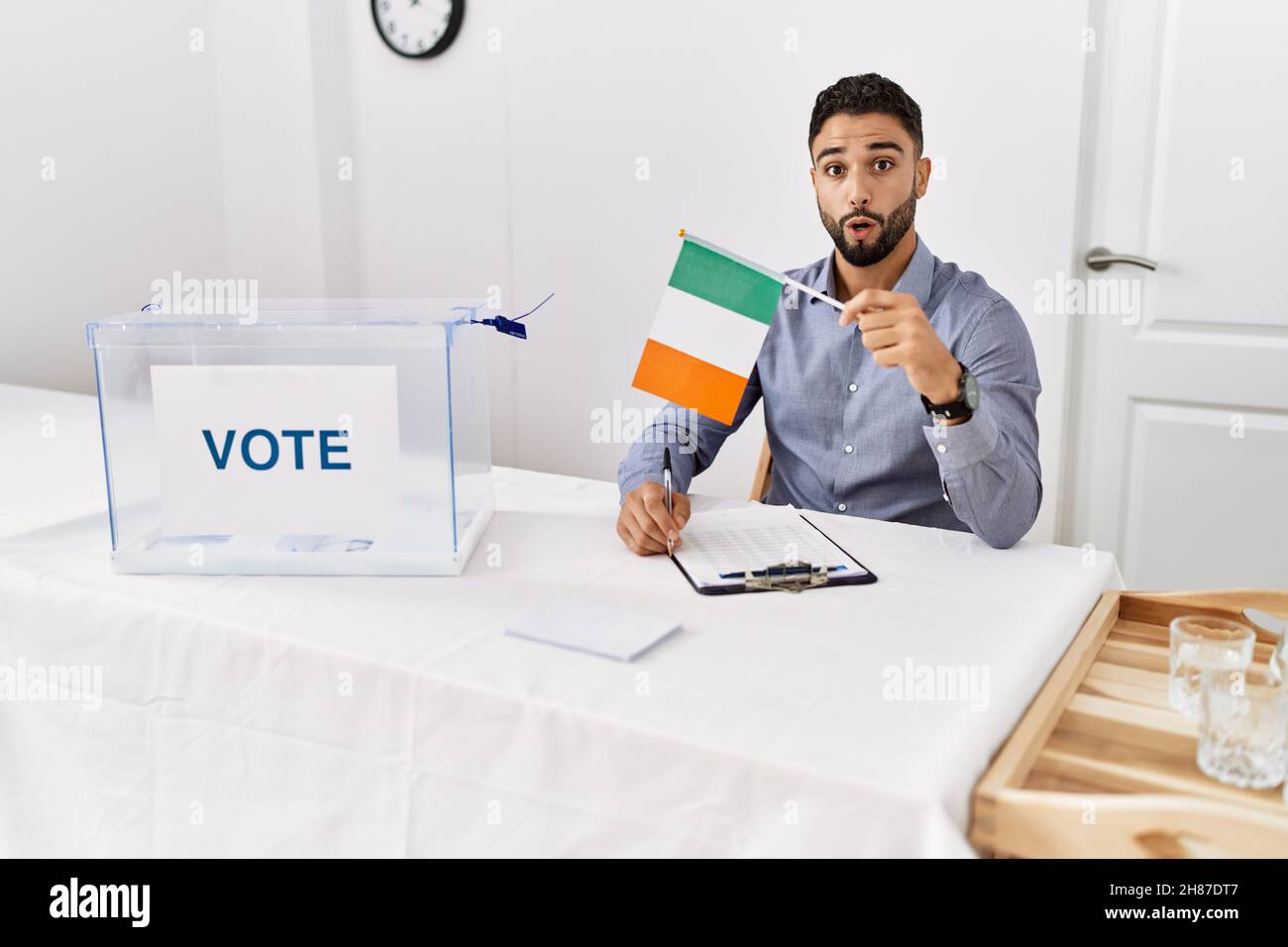 Young handsome man with beard at political campaign election holding ...