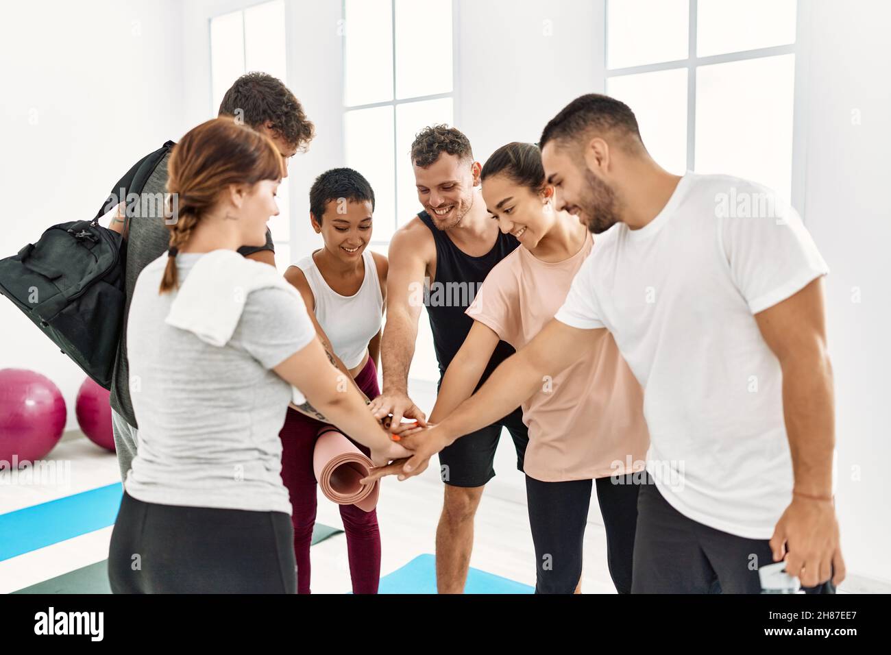 Group of young sporty people smiling happy with hands together at sport ...