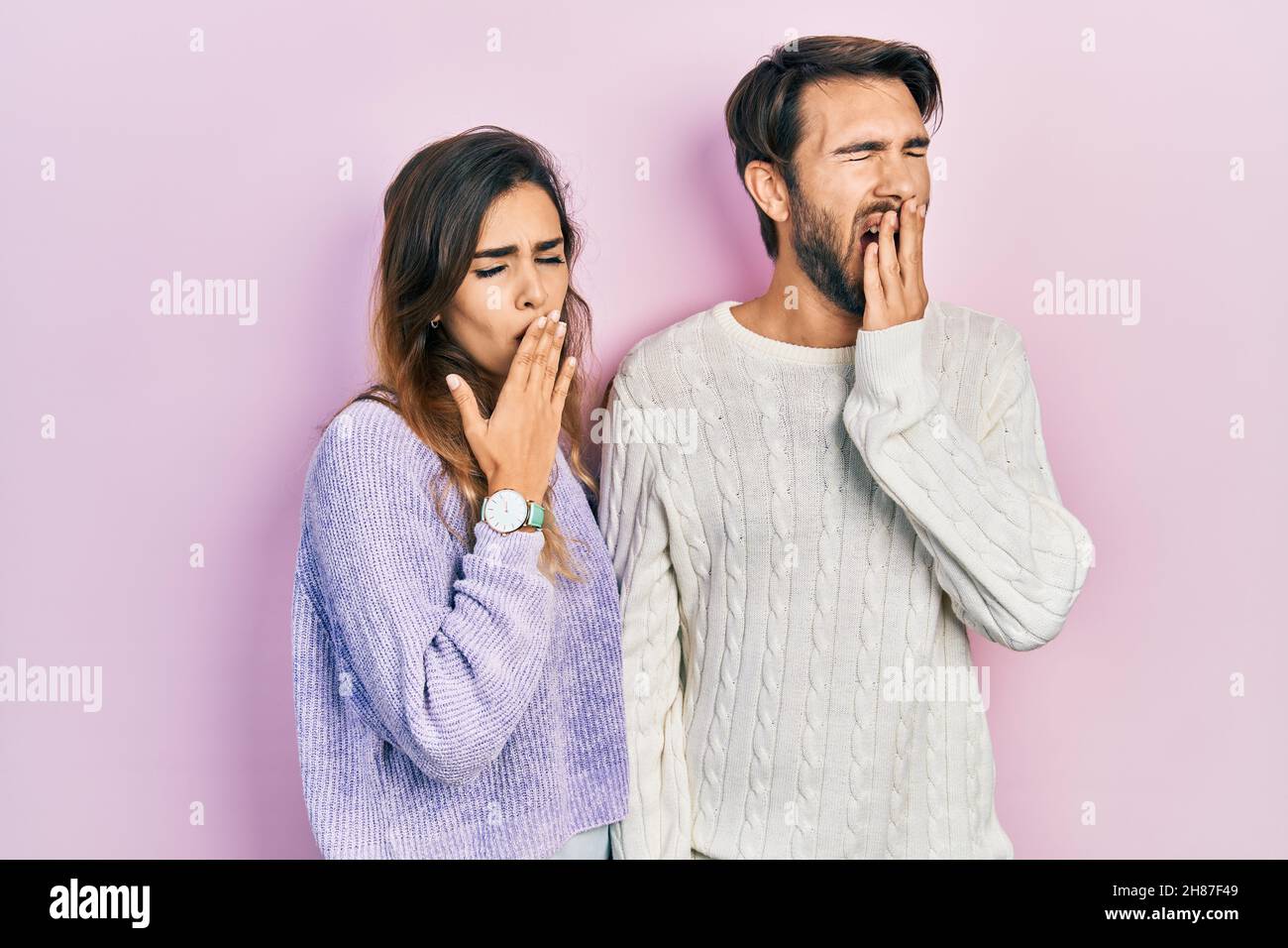 Young hispanic couple wearing casual clothes bored yawning tired ...