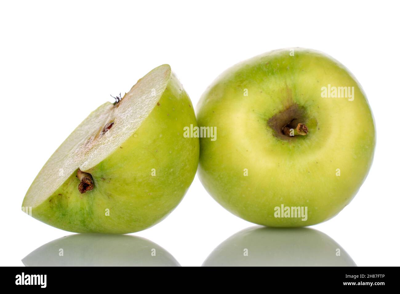 One half green apple of Renet Simirenko and one whole apple, close-up ...