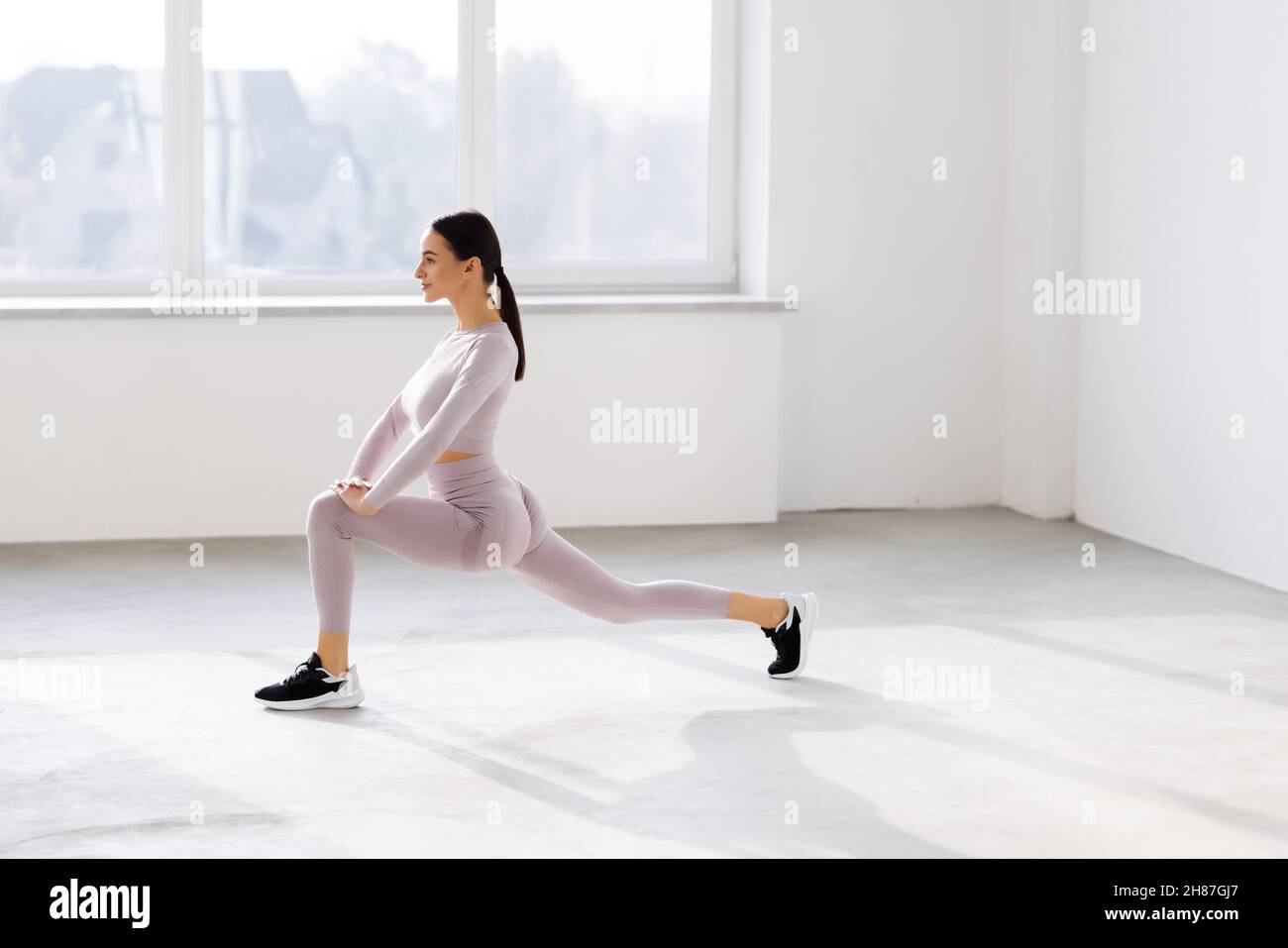 Fitness woman doing lunges exercises for leg muscle workout training ...