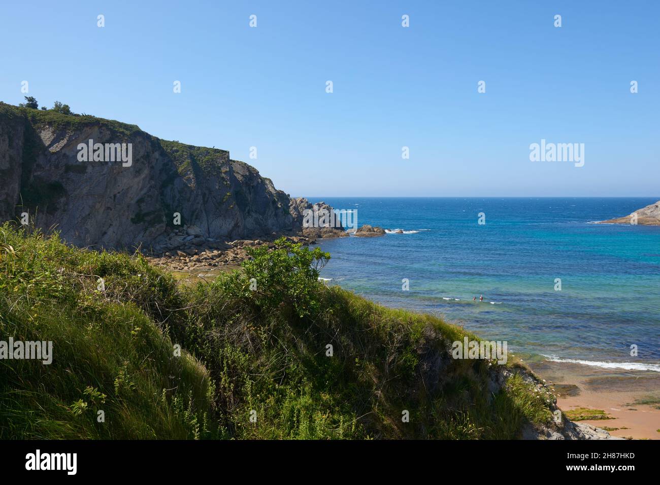 Steep cliffs next to a calm sea with a beautiful blue sky Stock Photo ...