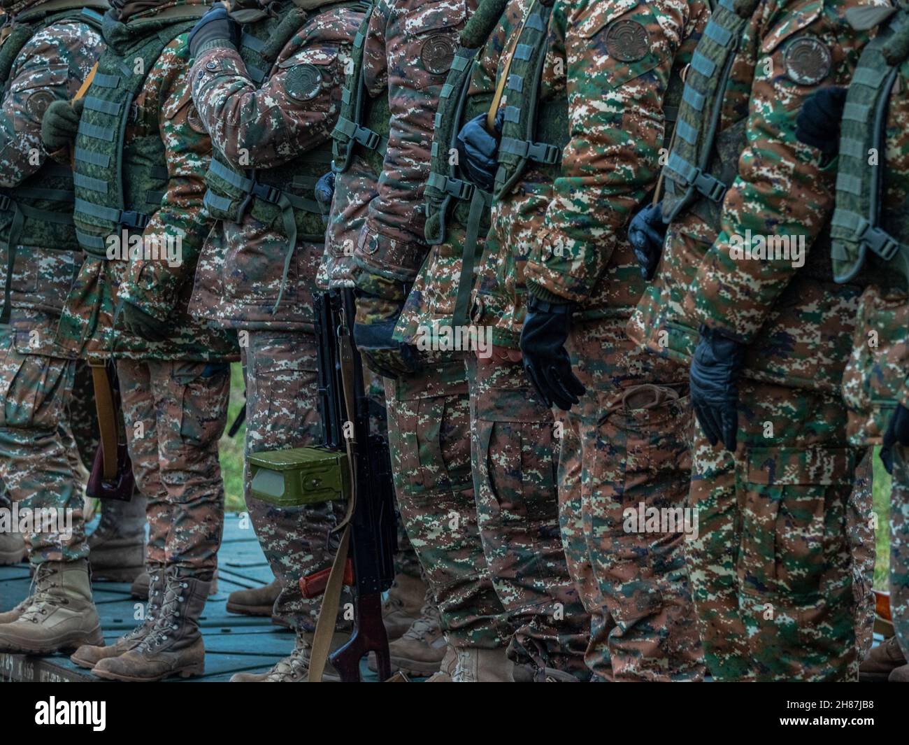 Armed soldiers in camouflage military uniform. Soldiers in formation ...