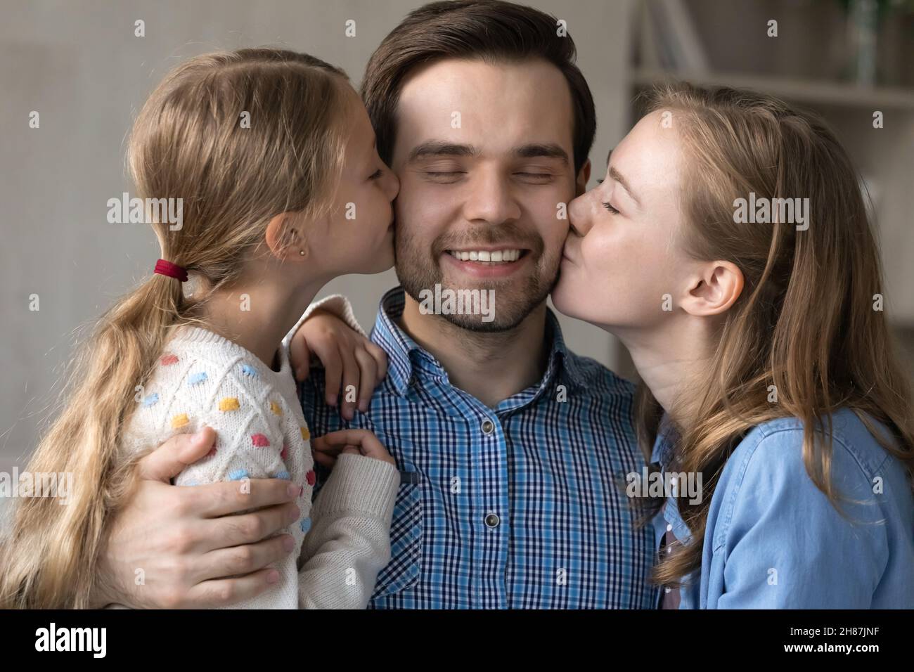 Affectionate family showing tender feelings at home Stock Photo - Alamy