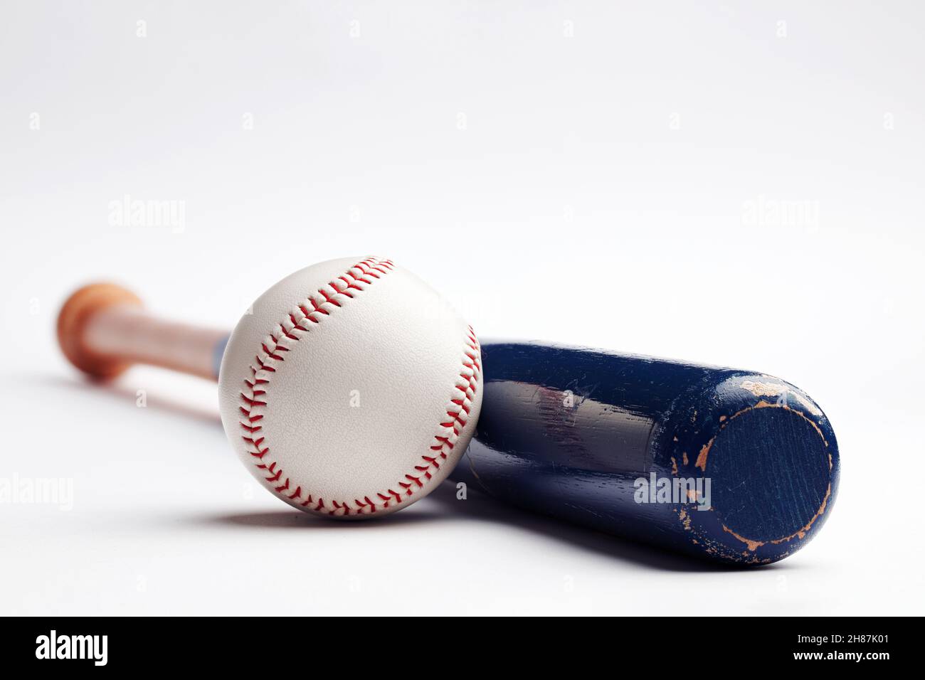 Baseball ball and blue wooden bat on white background with copy space ...