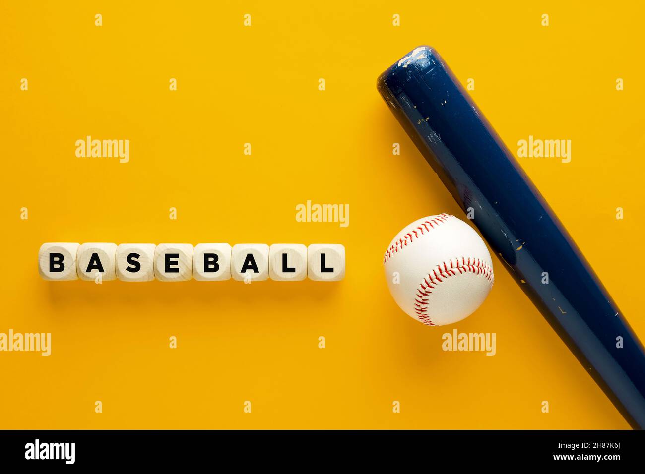 Baseball ball and blue wooden bat on yellow background with the word ...