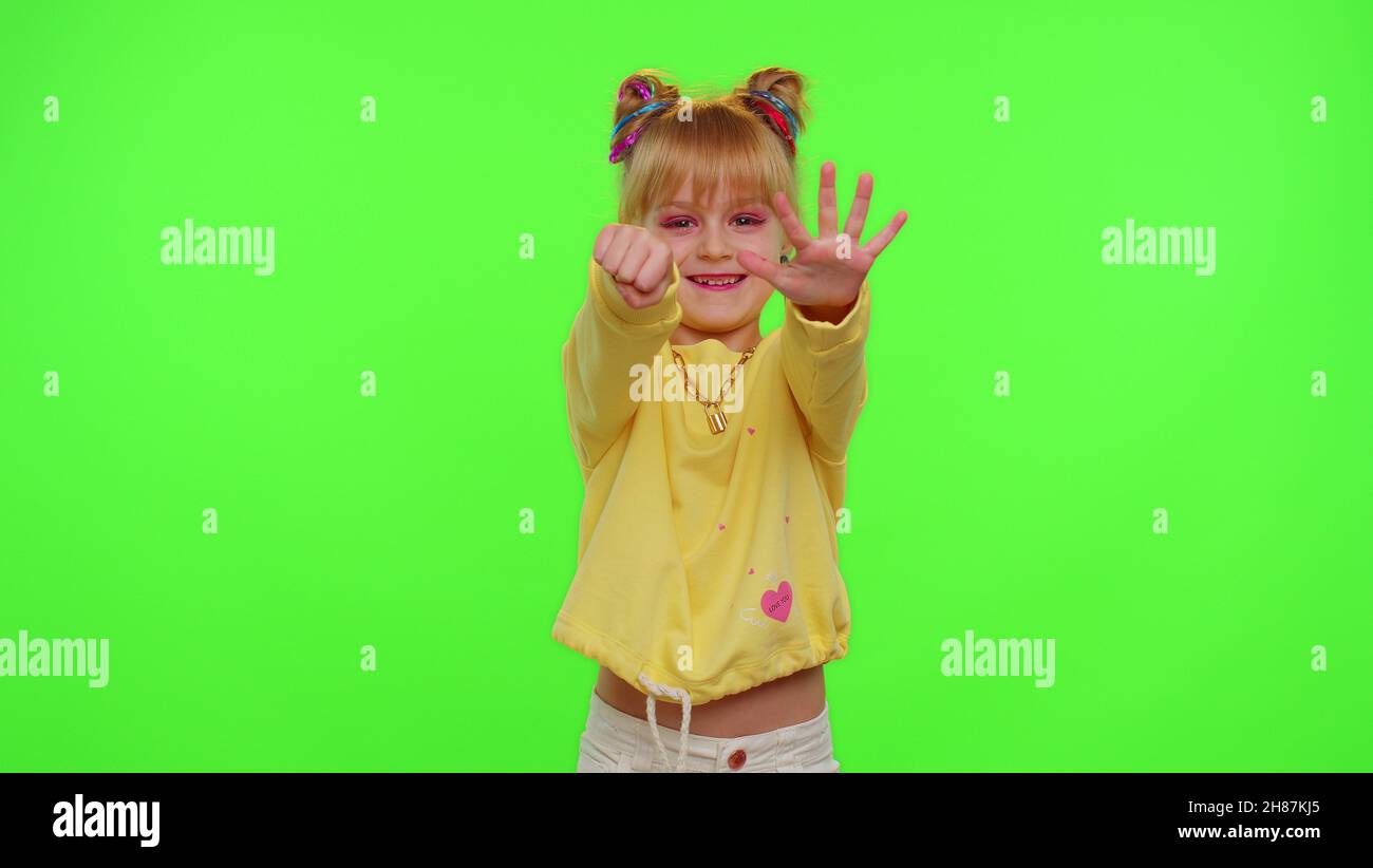 Happy little kid girl blogger front of phone camera record video enjoy ...