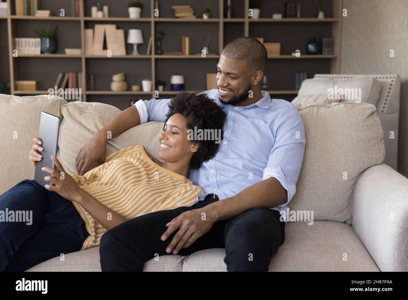 Happy African American married couple watching media content Stock ... Happy African American married couple watching media content Stock ...