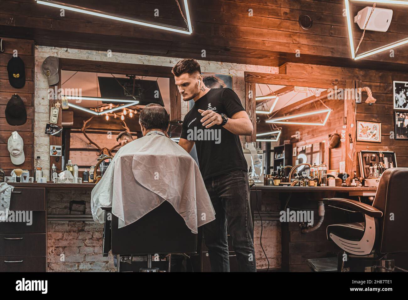 Barbershop. hairdresser professionally performs a haircut for men. man ...