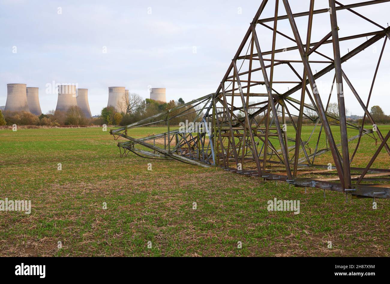 Old obsolete electricity pylon cut down in a field Stock Photo - Alamy