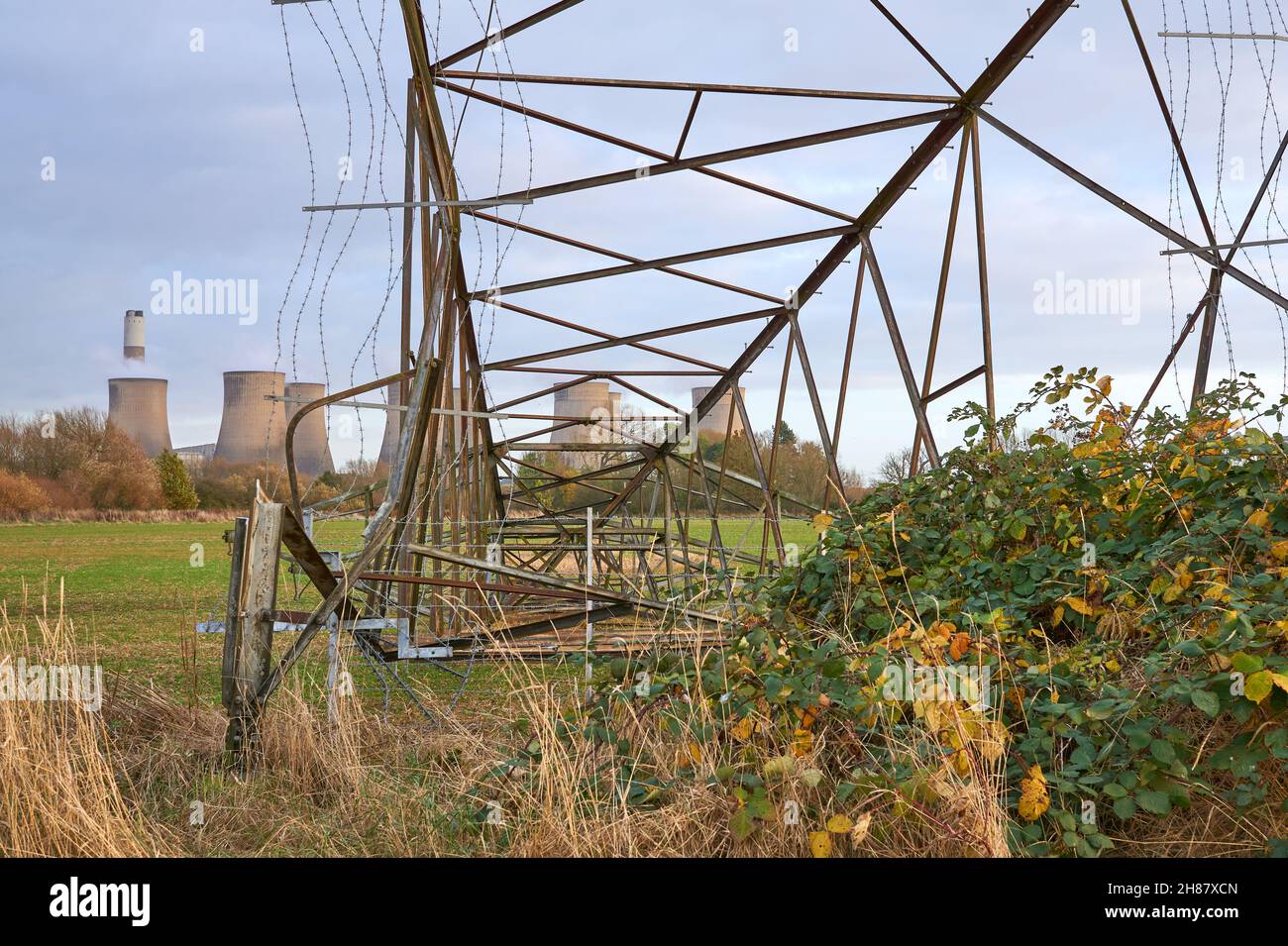 Old obsolete electricity pylon cut down in a field Stock Photo - Alamy