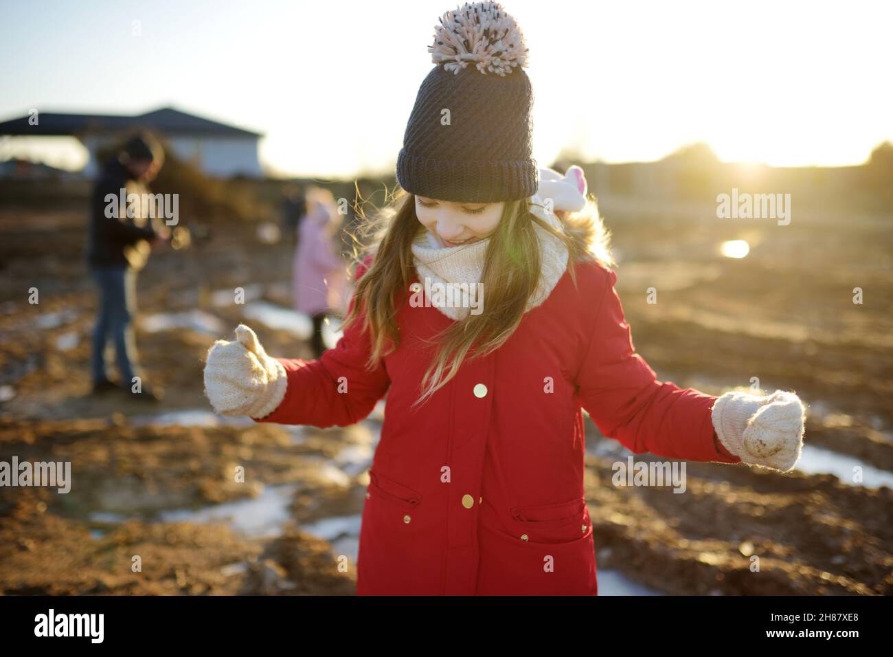 Group of children playing with thin ice puddles formed on the frozen ...