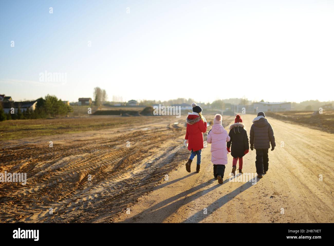 Four young kids having fun during a hike on beautiful early spring day ...