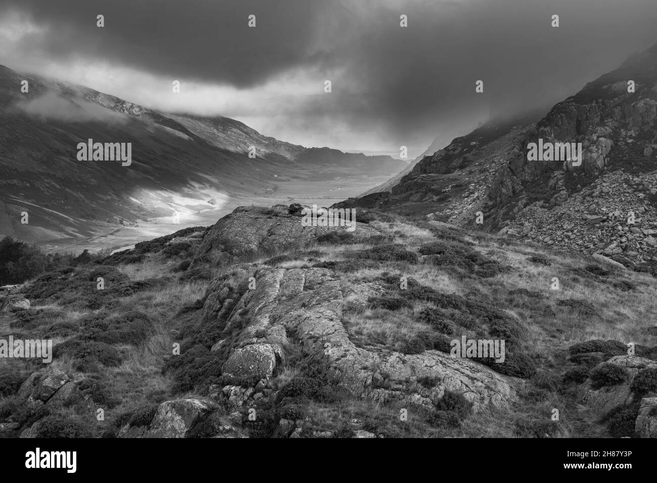 Black and white Epic Autumn landscape image of view along Nant Fracon ...