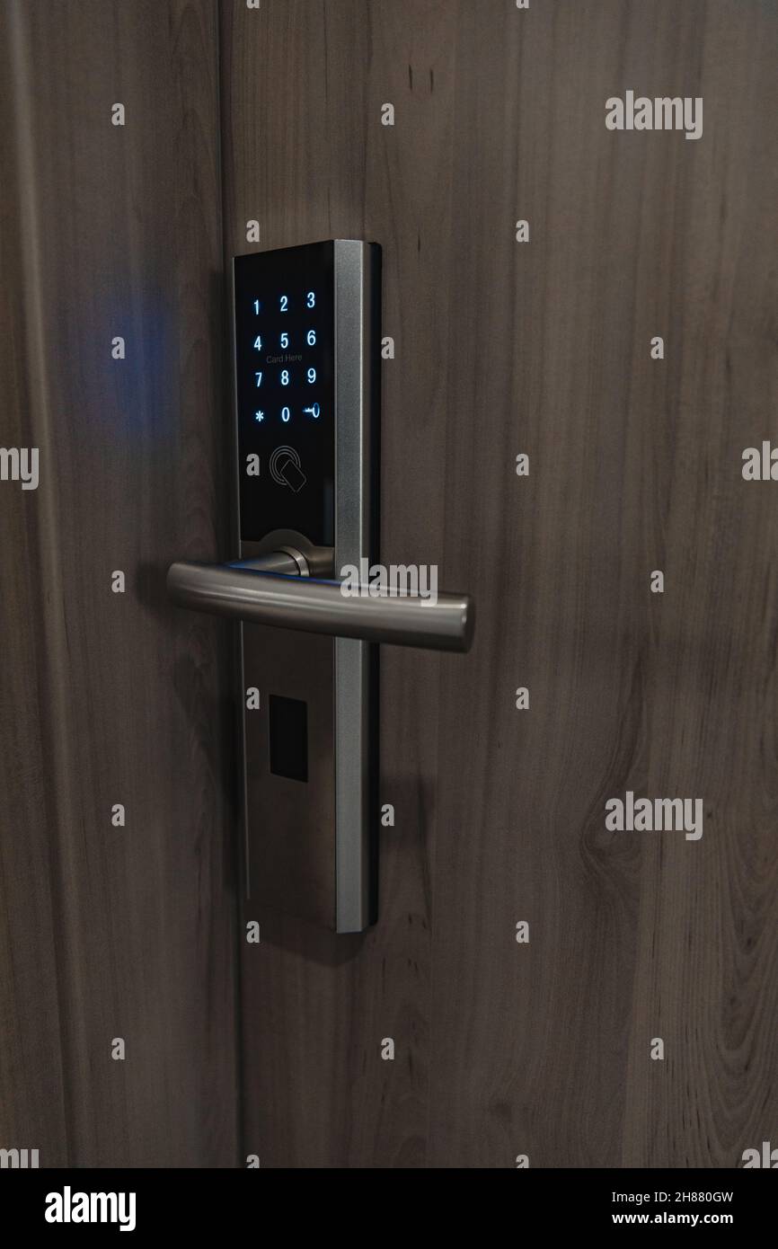 A vertical shot of a hotel room door lock - security concept Stock ...