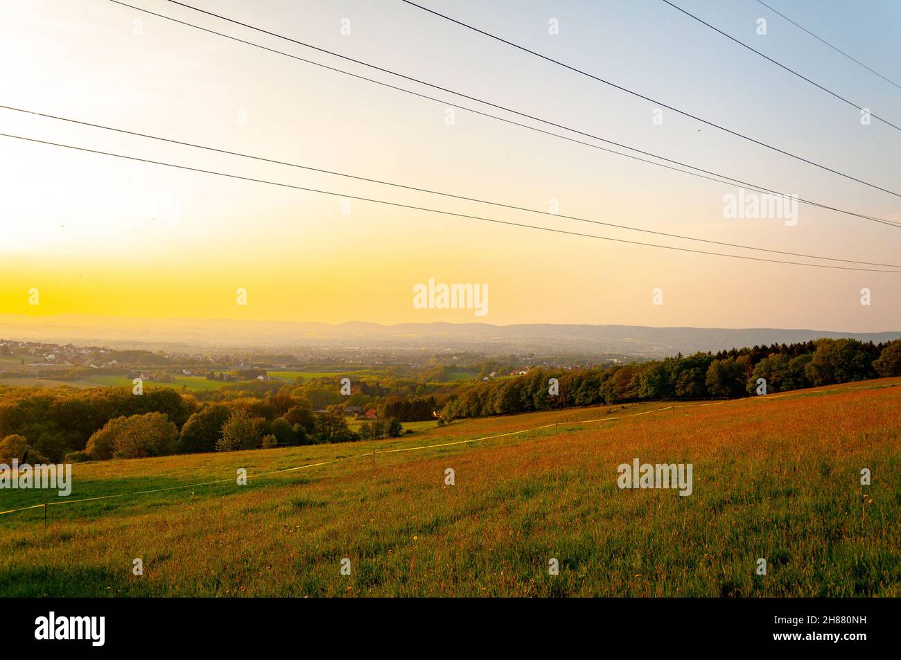 Beautiful and peaceful field with electrical transmitters during sunny ...