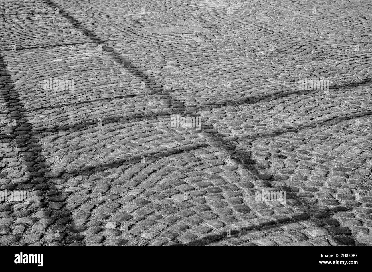 A grayscale of stone-tiled ground in the street Stock Photo - Alamy