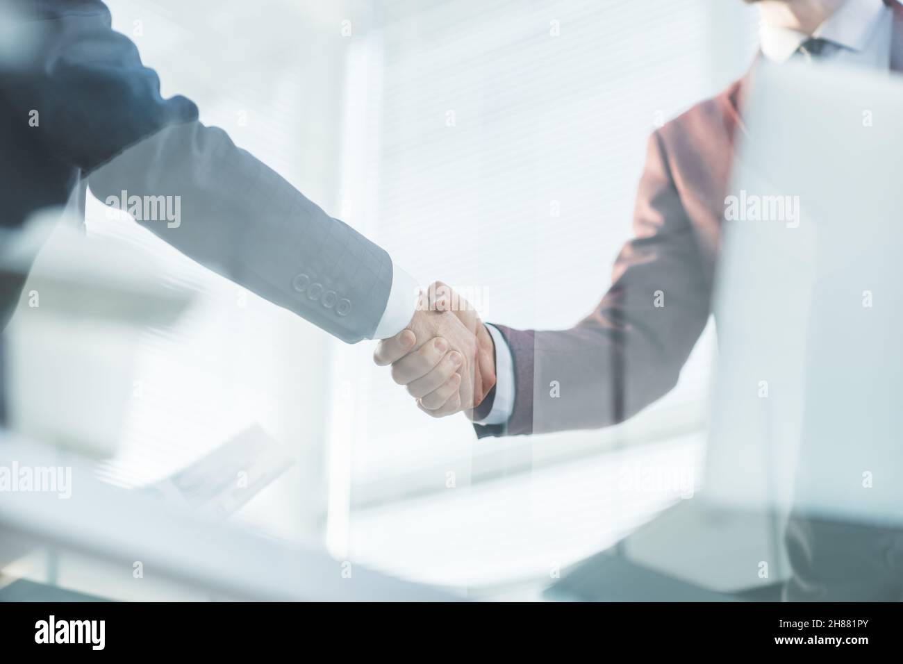 bottom view. handshake of business partners over the Desk Stock Photo ...