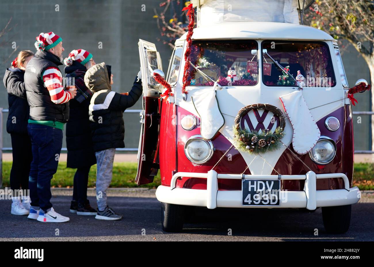 People look at the Christmas decorations on a VW camper van during the ...